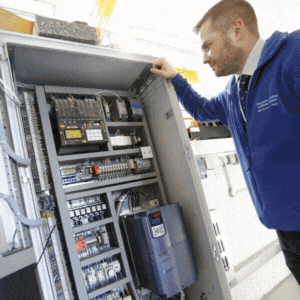 An experienced lift engineer performs regular service inspections to ...